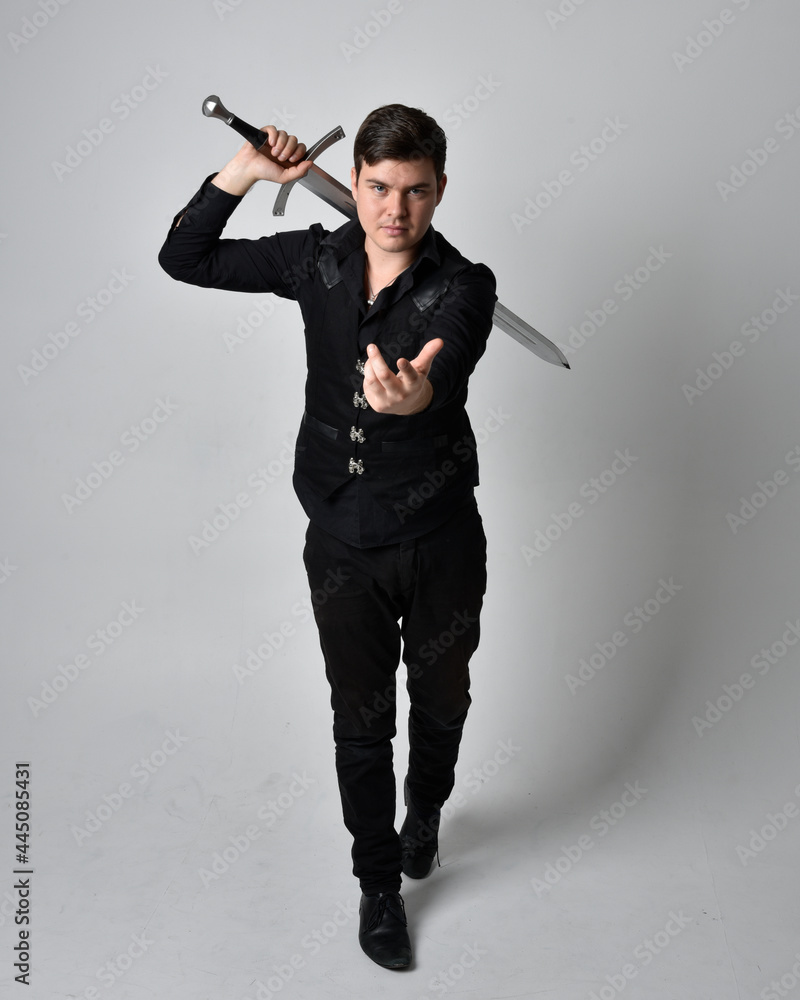 Full length portrait of a brunette man wearing black shirt and gothic ...
