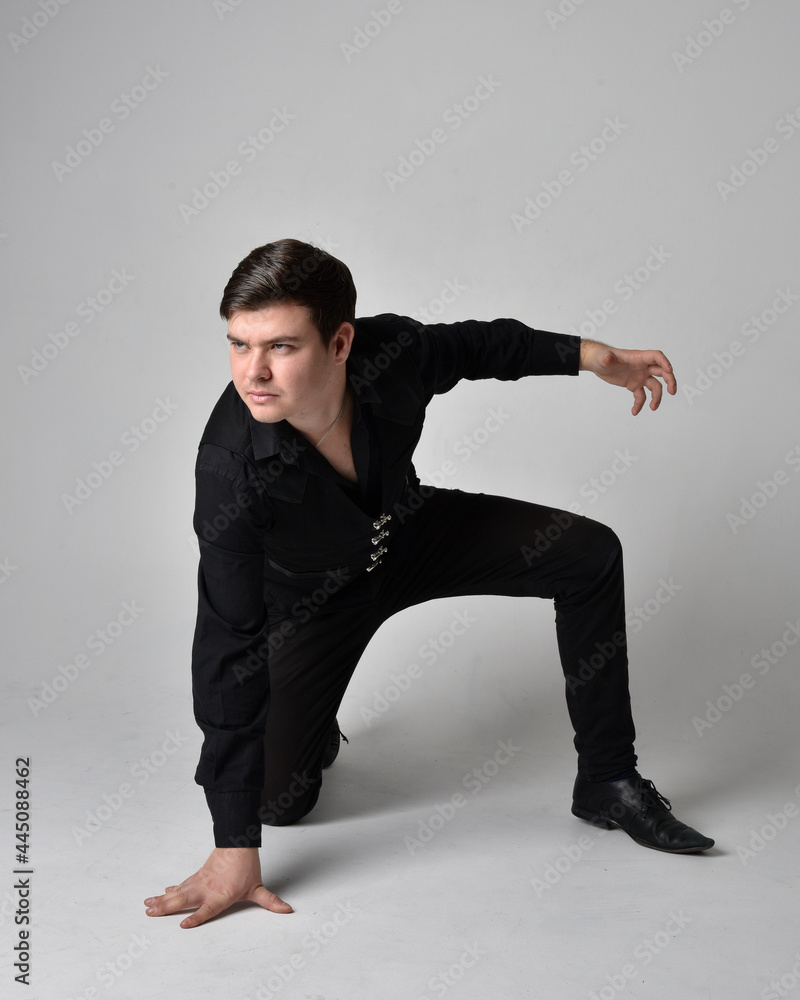Full length portrait of a brunette man wearing black shirt and gothic ...