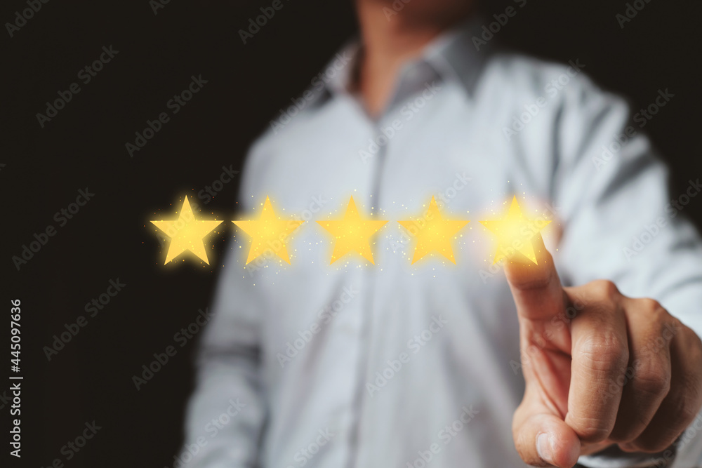 Customer satisfaction concept. hand holding the stars to complete five ...