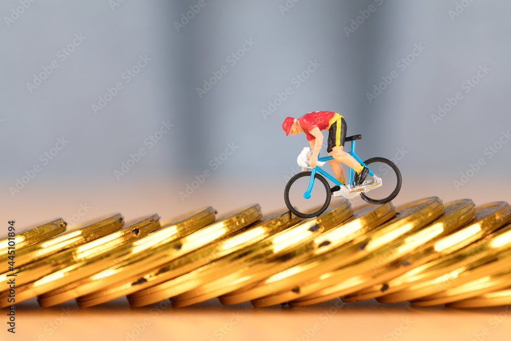 Characters who are trying hard to ride on gold coins Stock Photo ...