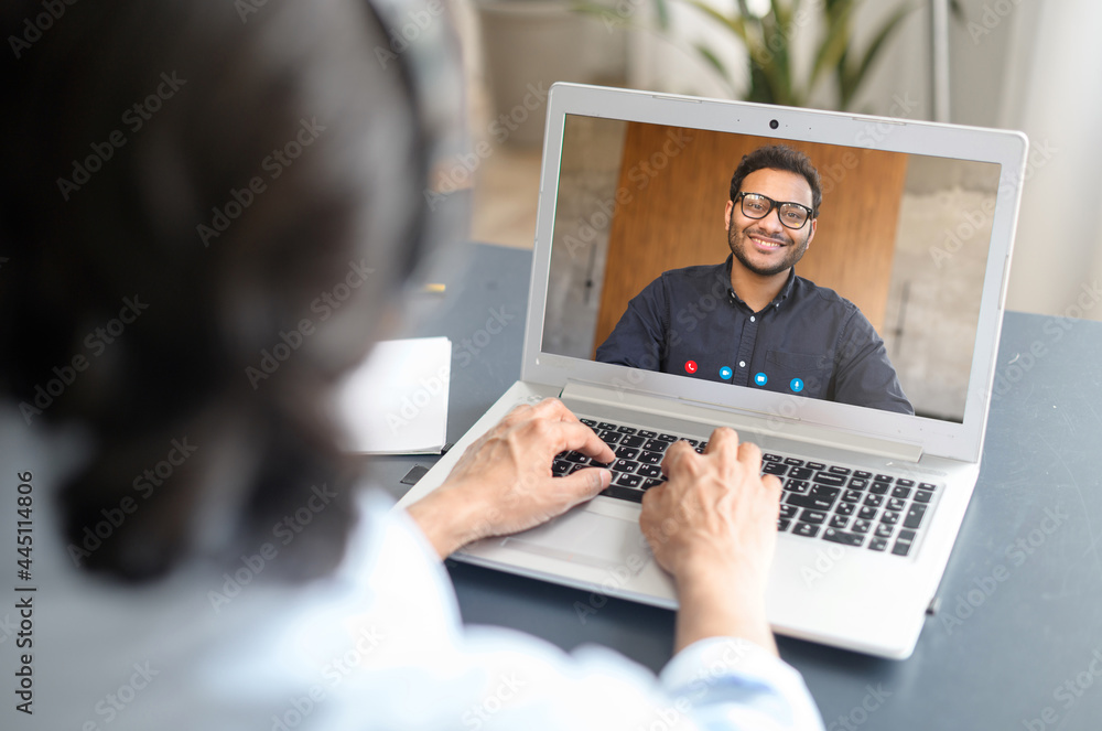Two indian colleagues or friends speaking through the screen, using ...