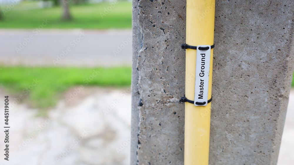 Ground conduit on pole-closeup. The master ground conduit of the short ...