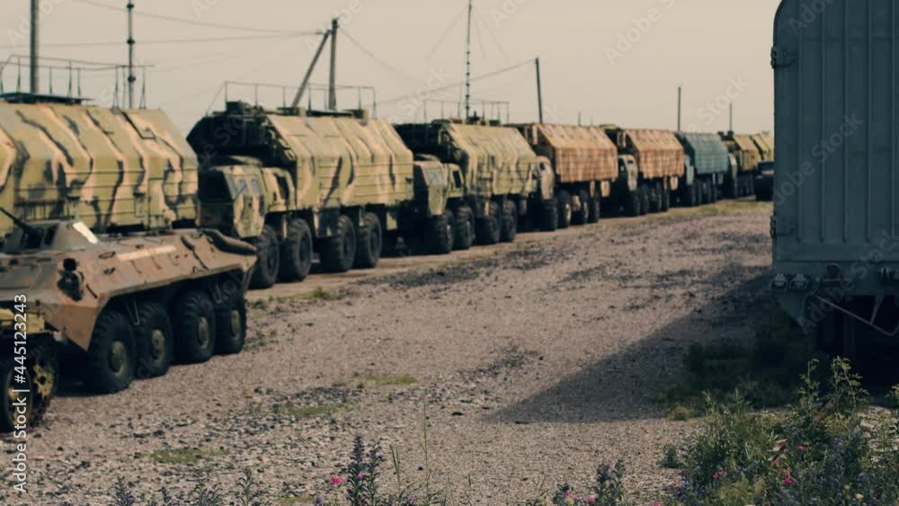 Mobile military armored vehicles stand in a column. The cars have ...