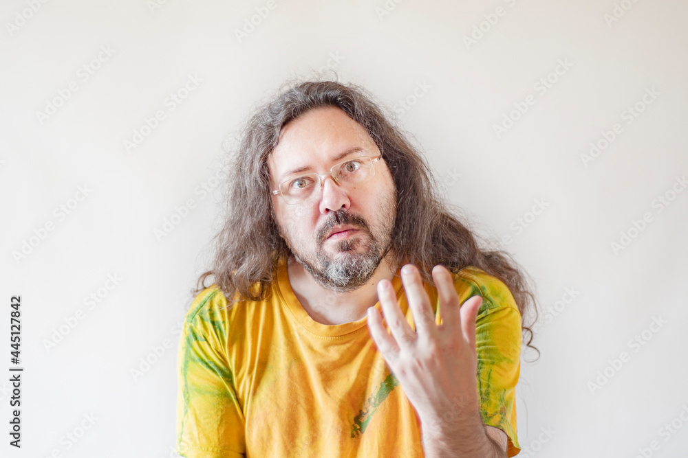 The man looks ahead in surprise and questioning. A casually and sloppy ...