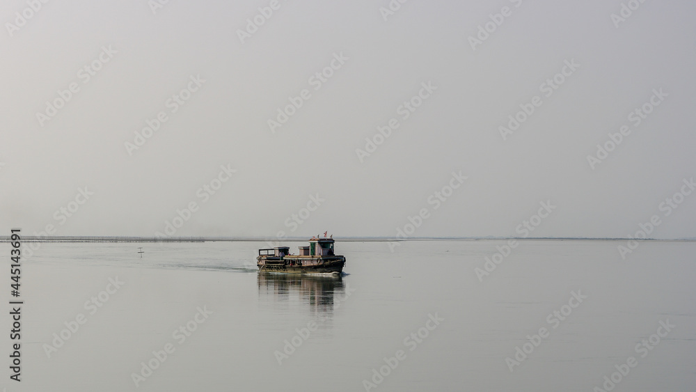 Minimalist landscape view of small wooden ferry boat crossing the ...