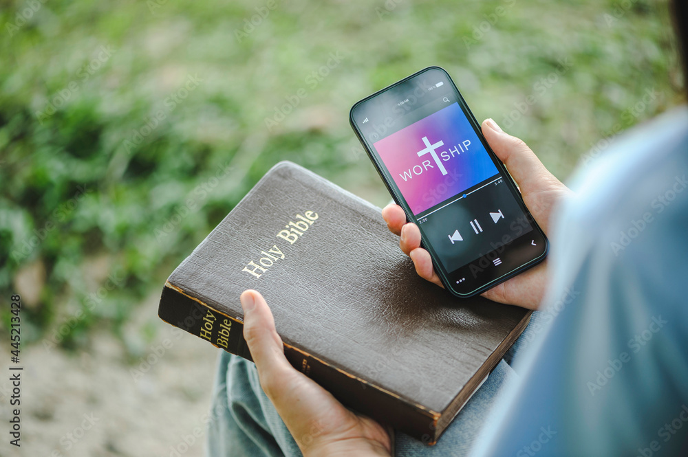 Women holding mobile phone praying worship to God with church online ...