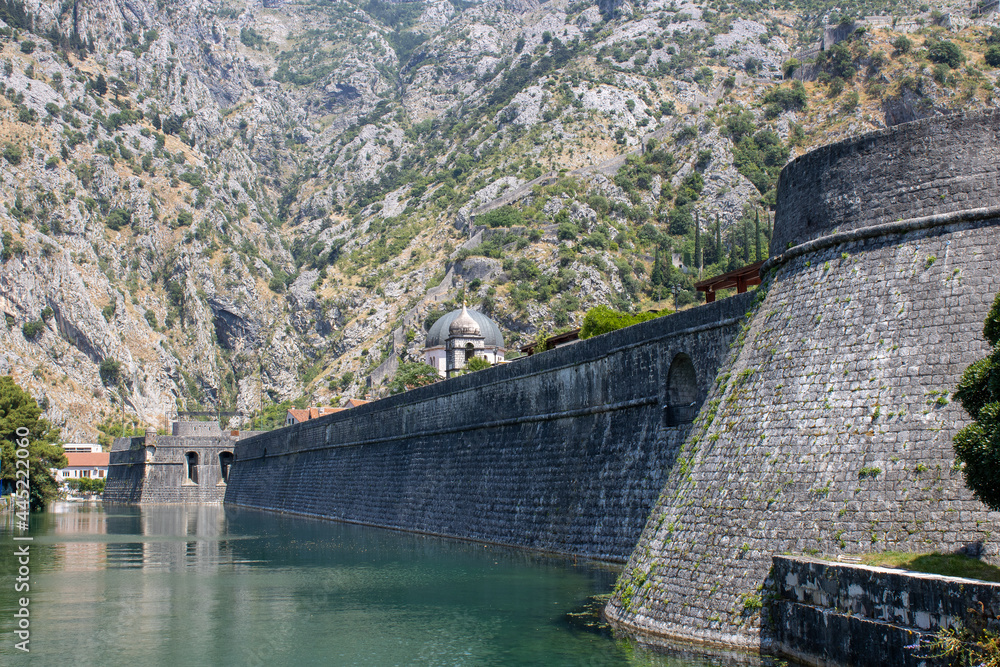 Medieval security wall surrounding the old town. Military tower ...