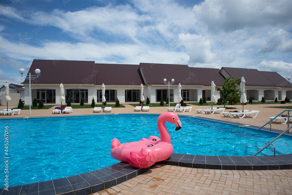 Flamingo pool float in swimming pool blue water background. Flamingo ...