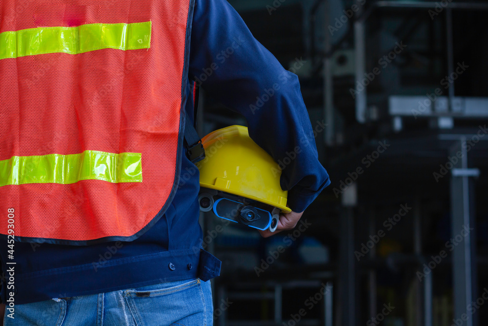 yellow helmet safety in construction site. helmet and reflective vest ...