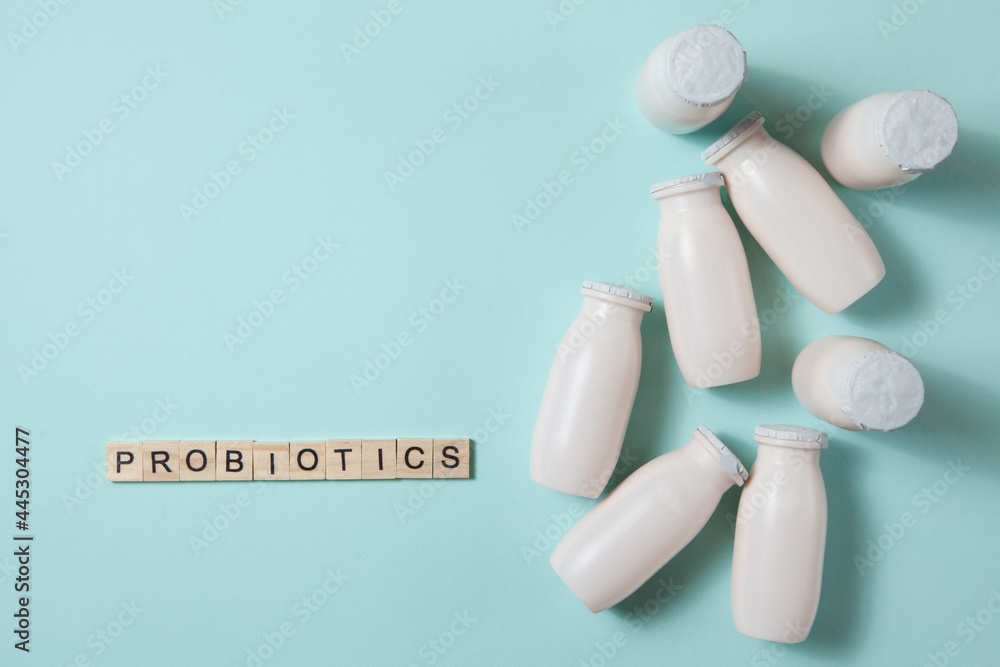 Bottles with probiotics and prebiotics dairy drink on light blue ...