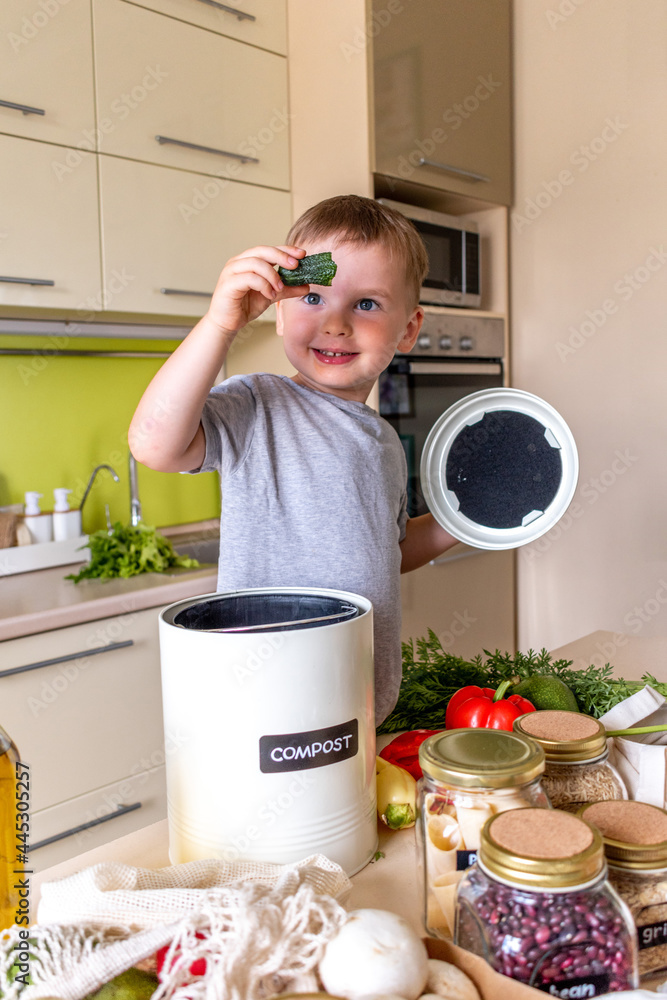 Child boy puts food waste in a compost bin. Waste sorting. Stock Photo ...