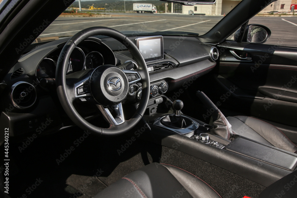 Mazda MX-5, is a lightweight two-seater roadster with a front-engine ...