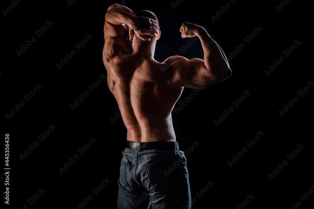 Bodybuilder showing his back and biceps muscles Stock Photo | Adobe Stock