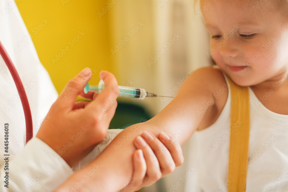 A nurse doctor makes an injection to a child's baby at home in a ...