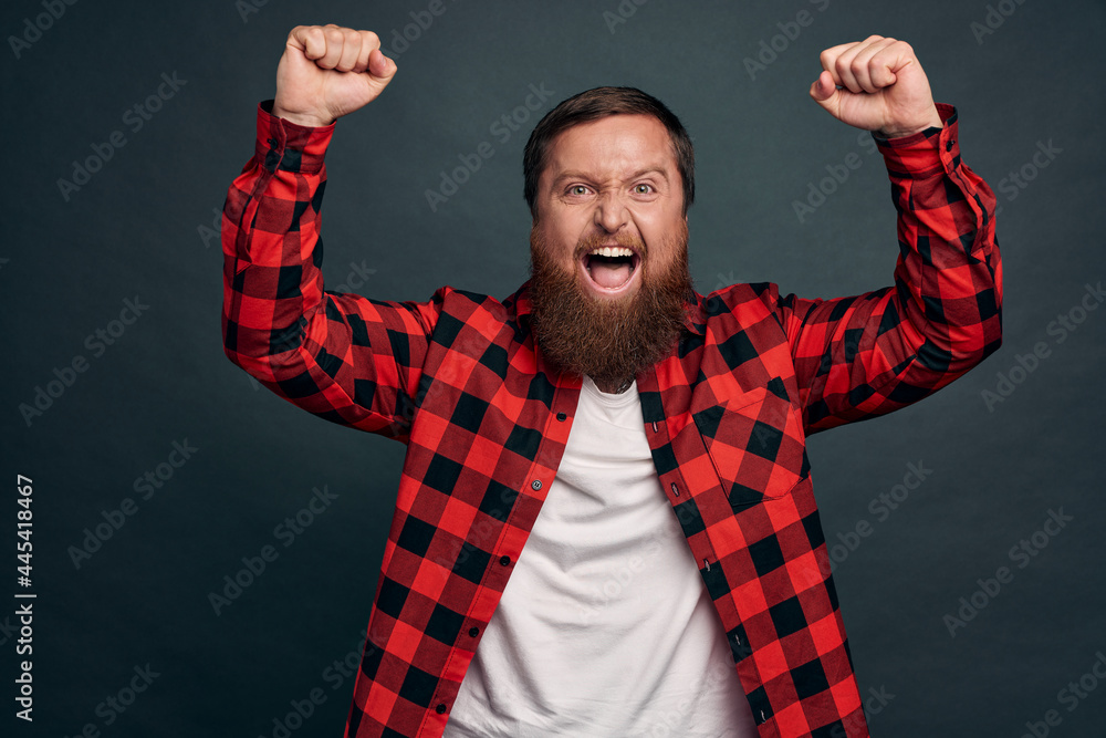 Delighted young macho man, football fan celebrating victory feeling ...