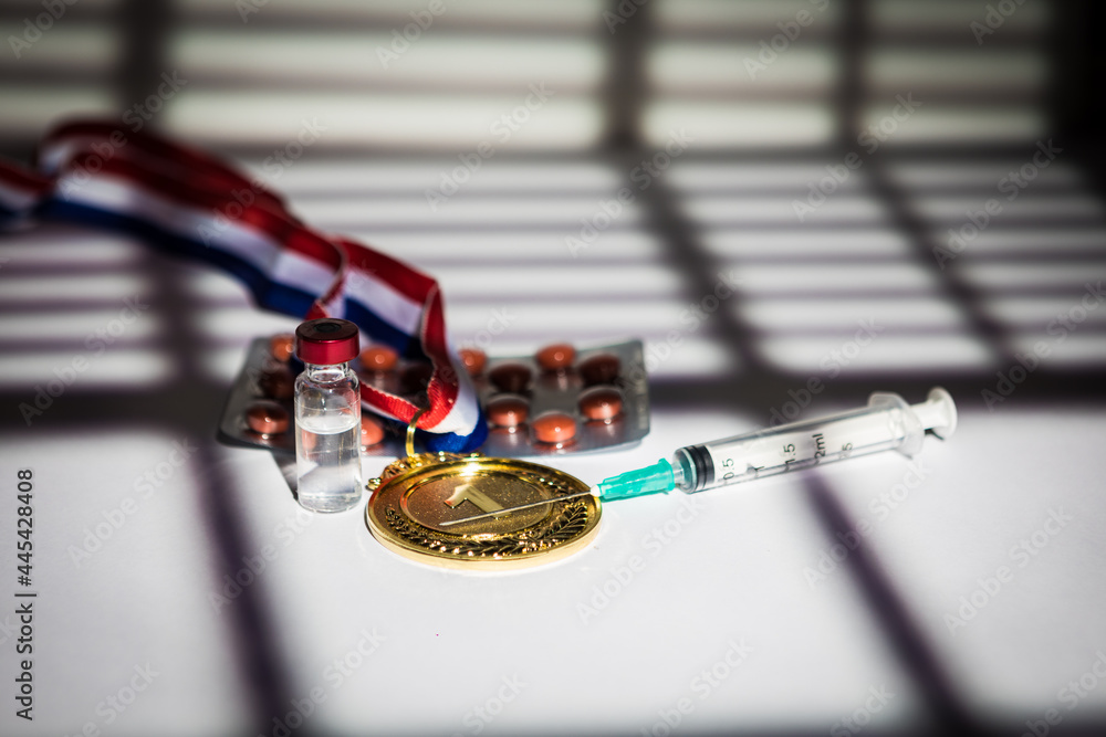 Champion gold medal, doping substance syringe, pill tablet and ...