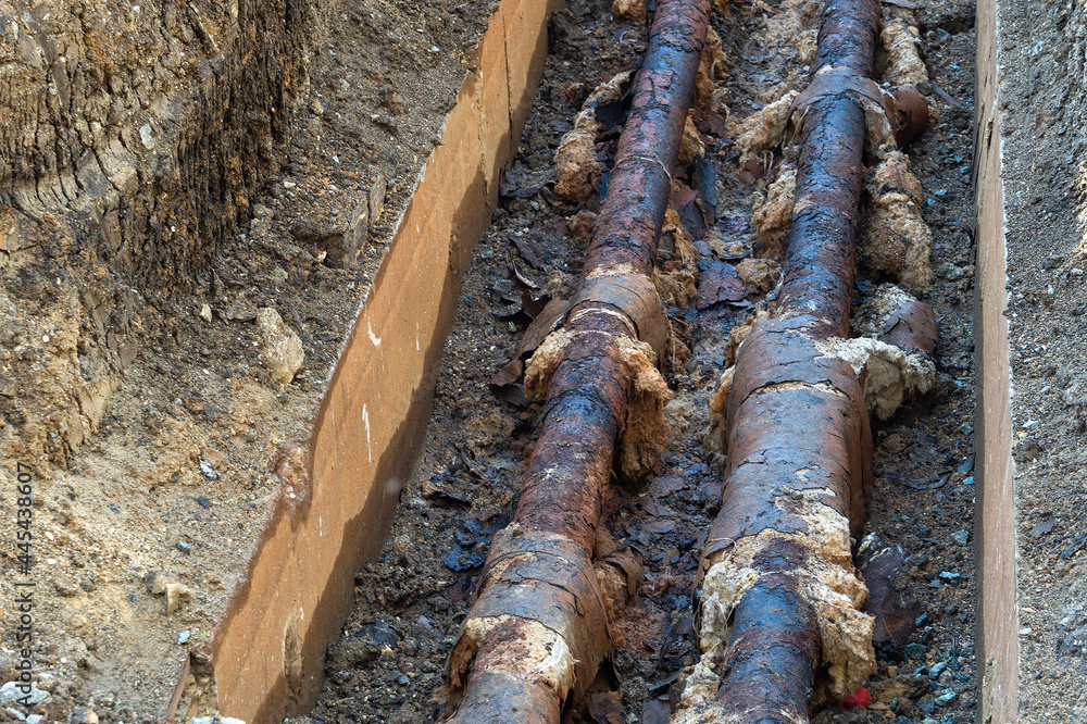 Old rusty sewer pipes in a trench. Repair of old pipes. Old pipes were ...