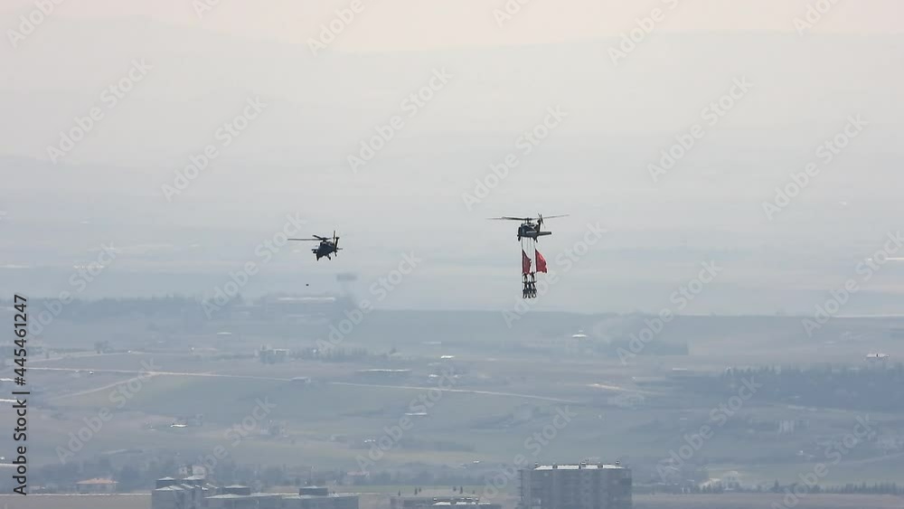 People hanging from helicopter performing stunt flying.Aerobatics ...