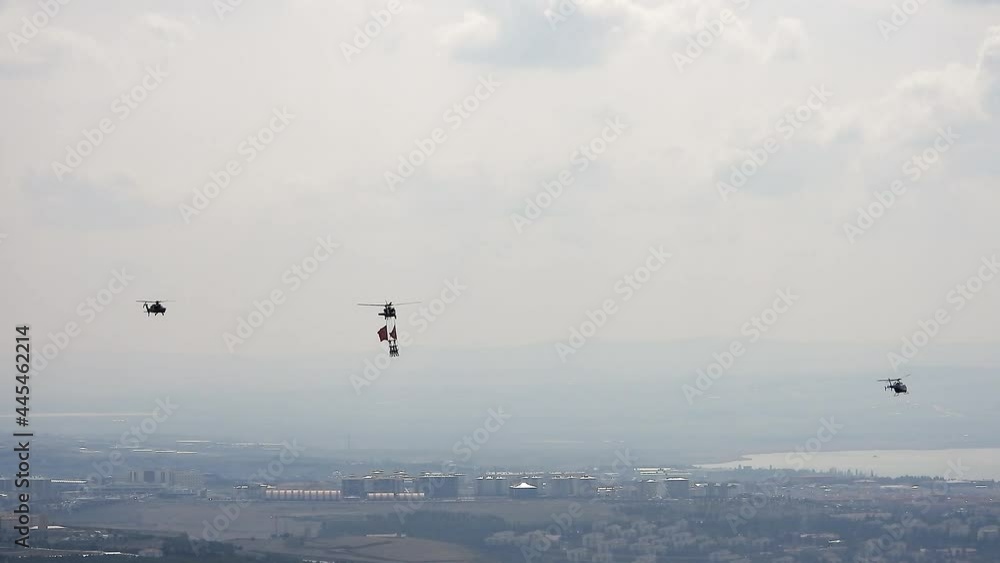 People hanging from helicopter performing stunt flying.Aerobatics ...