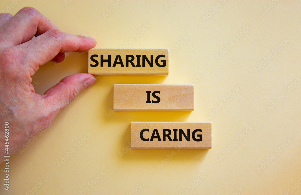 Sharing is caring symbol. Wooden blocks with words 'Sharing is caring' on beautiful white ...
