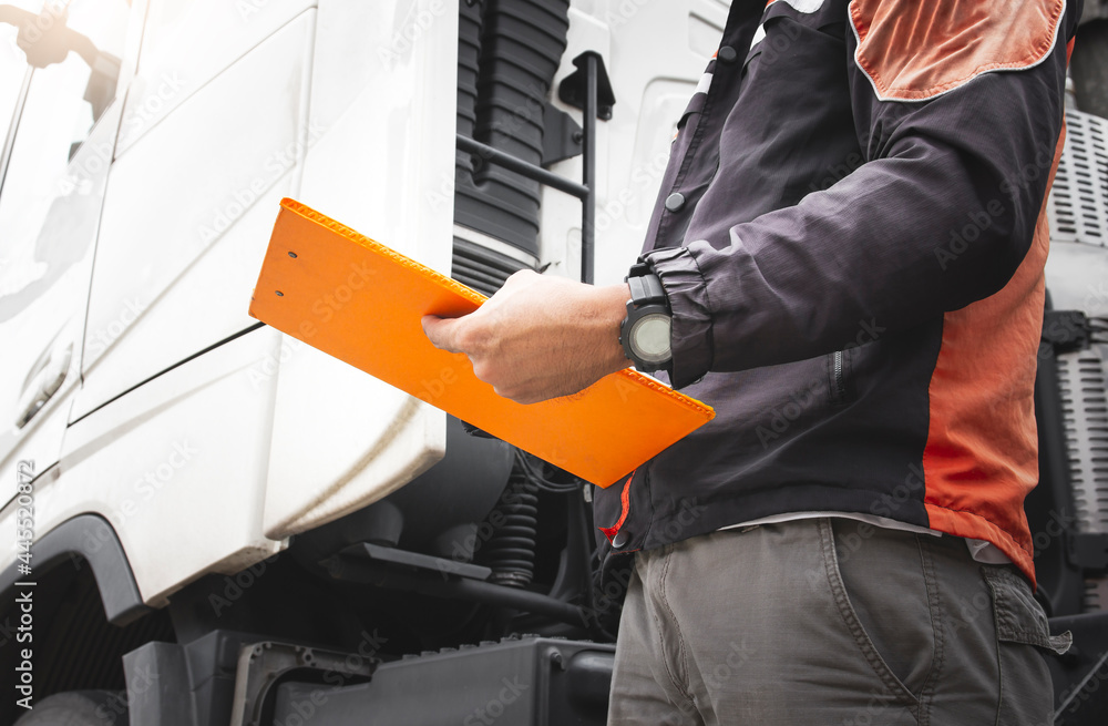 Truck Driver is Checking the Semi Truck's Engine Maintenance Checklist ...