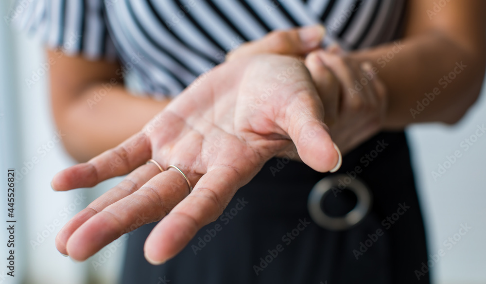 Woman shows hand and hold wrist with feeling pain, suffer, hurt and ...