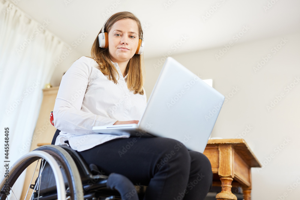 Disabled woman in wheelchair using laptop computer Stock Photo | Adobe ...