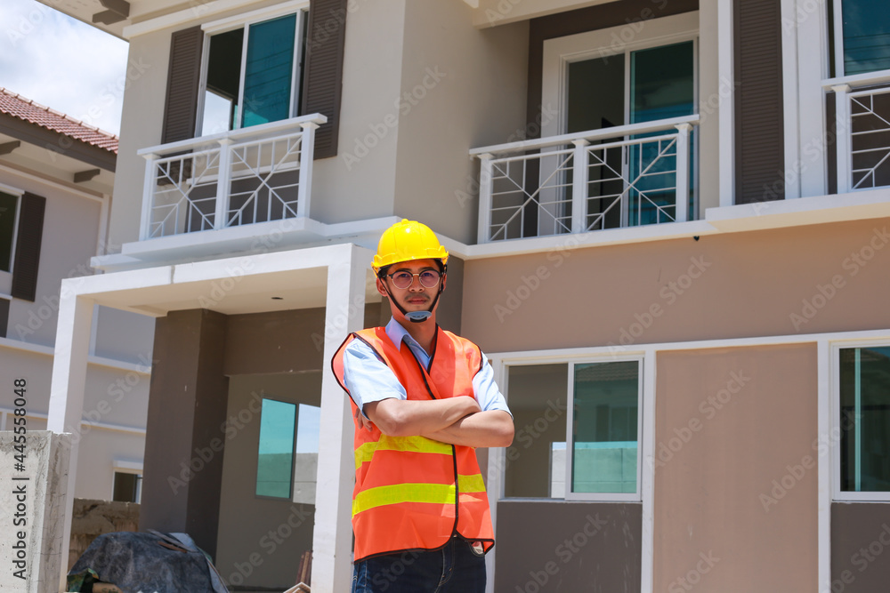 Asian male foreman constructor standing with his arms crossed with a ...