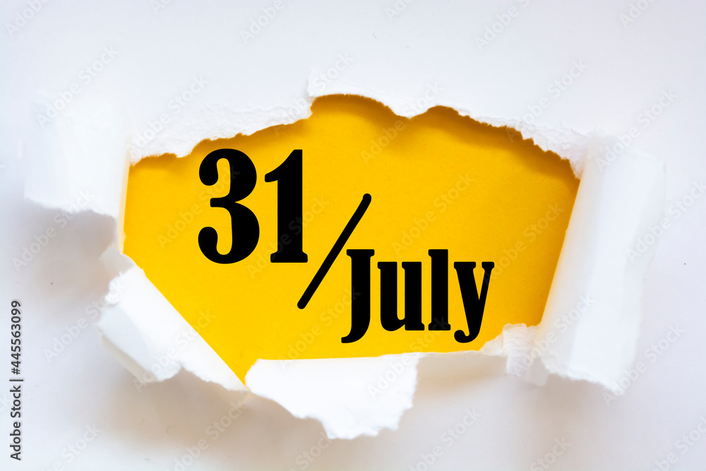 July 31. 31th day of the month, calendar date. Hole in paper with edges ...