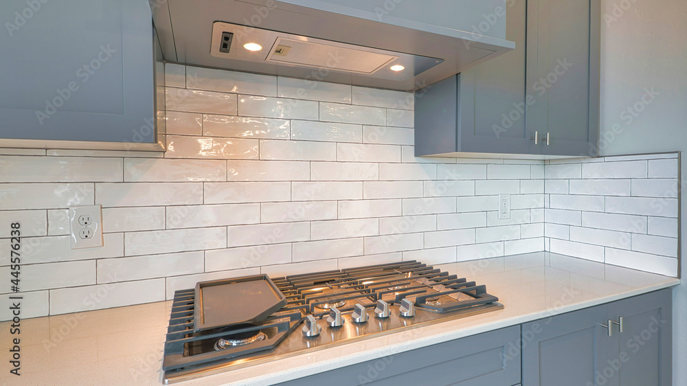 Pano Cooktop stove fixed on kitchen countertop with exhaust hood and ...