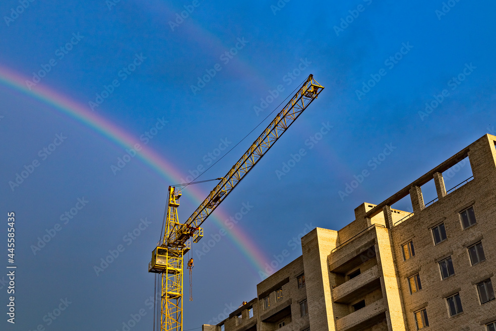 Yellow construction building cranes on the construction site of a large ...