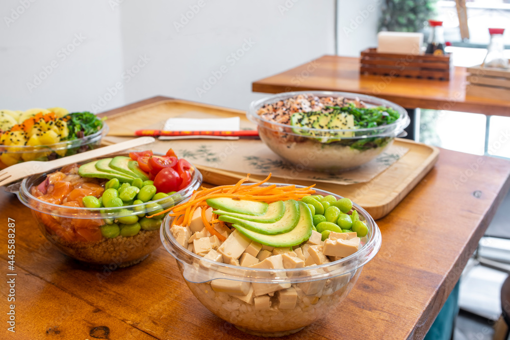Poke bowl with diced tofu, edamame beans, avocado slices, base white ...