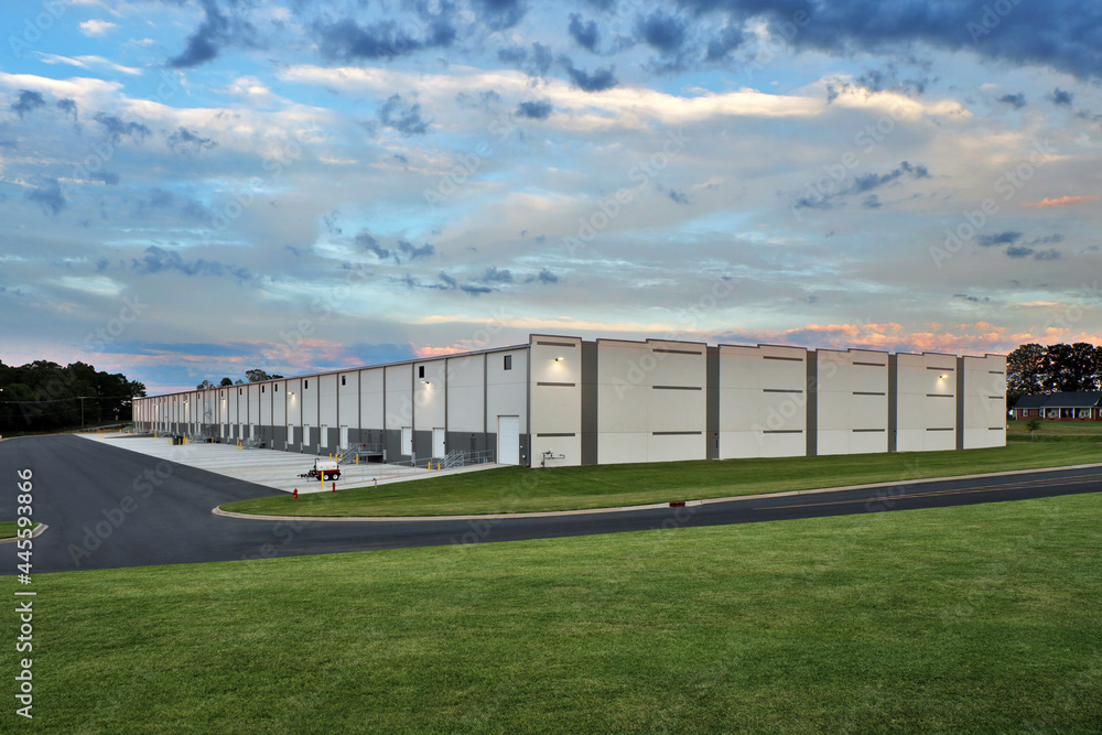 Modern generic gray and white industrial warehouse building façade at ...