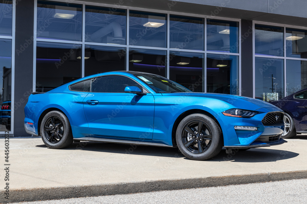 Ford Mustang display at a dealership. Ford offers the Mustang in a base ...