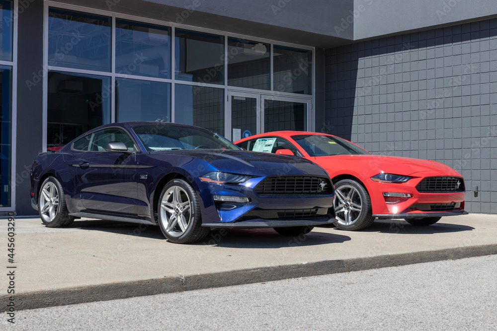 Ford Mustang display at a dealership. Ford offers the Mustang in a base ...