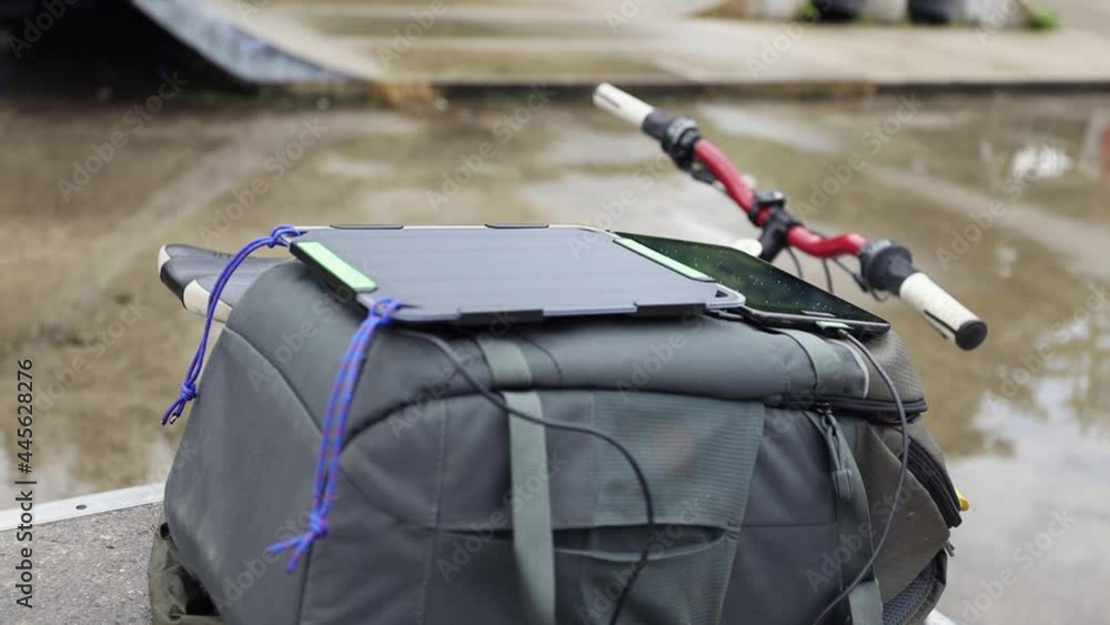 Concept of renewable energy. Tablet is charged from a portable solar ...