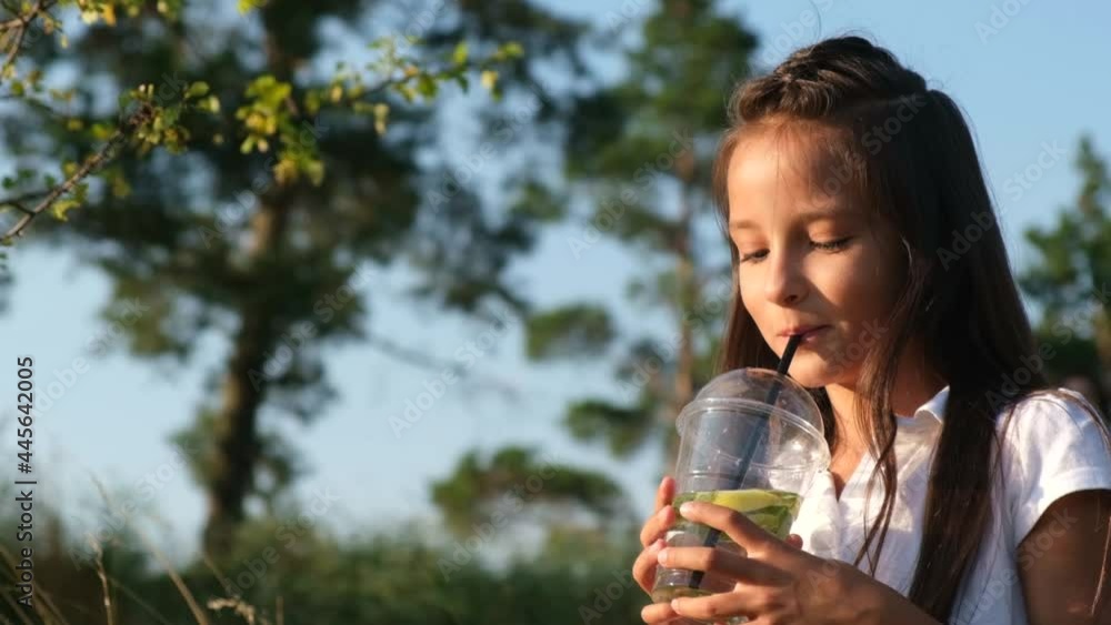 Little girl drinks a cold cocktail on a hot summer day. Stock Video ...