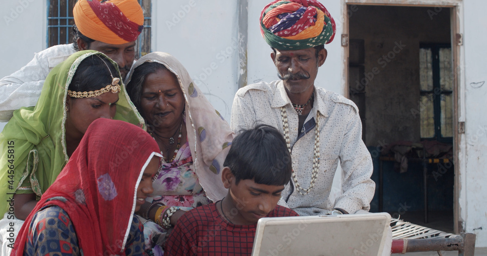Group of South Asian people in traditional Indian clothing using a ...