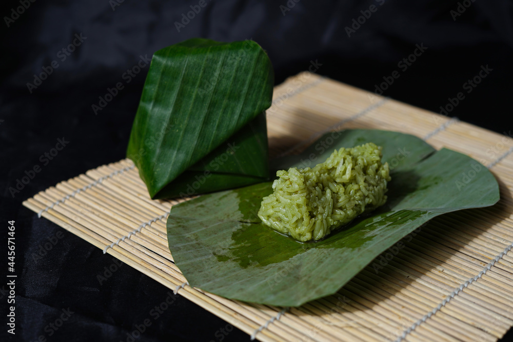 Green sticky rice tapai isolated on a black background. Tapai is a ...