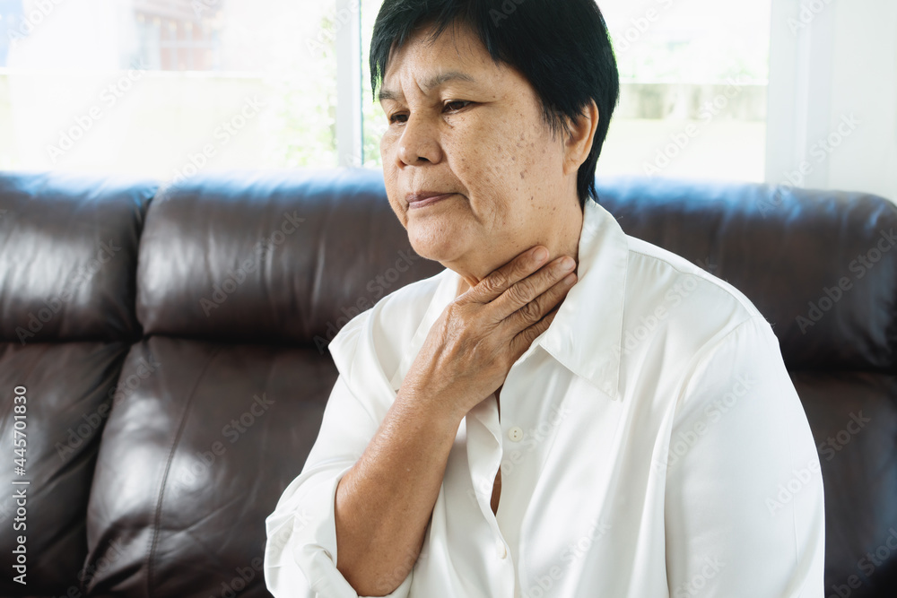 Senior adult women touching the neck feeling unwell coughing with sore ...