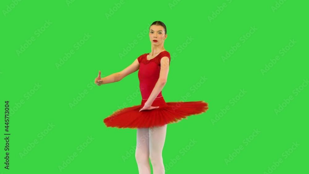 Young ballerina in red classical tutu turns en pointe and makes a ...