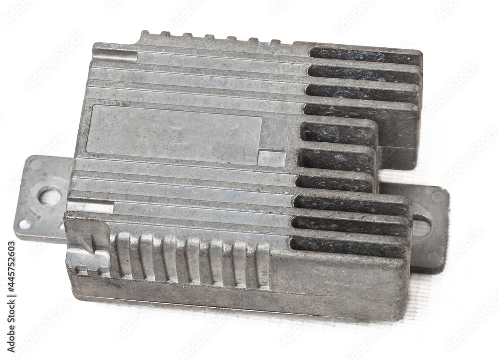 Metallic car engine control unit with plastic elements on a white ...