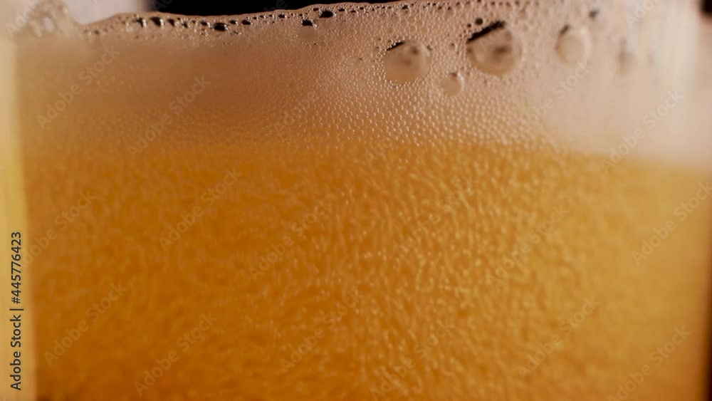 Extreme macro footage through a transparent glass of bubbles within ...