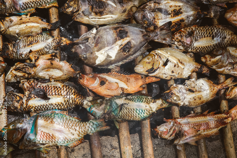 Lots of undercooked fish grilled on a traditional grill Stock Photo ...