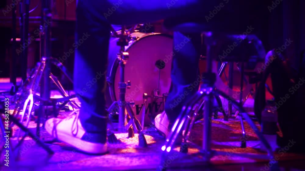 slow motion 120fps shot in purple red blue ambient lighting of drummers ...