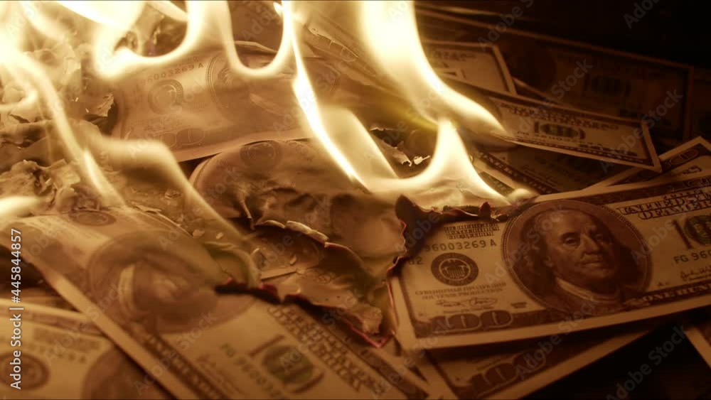 Pile of hundred dollar bills lie on floor against dark background and ...