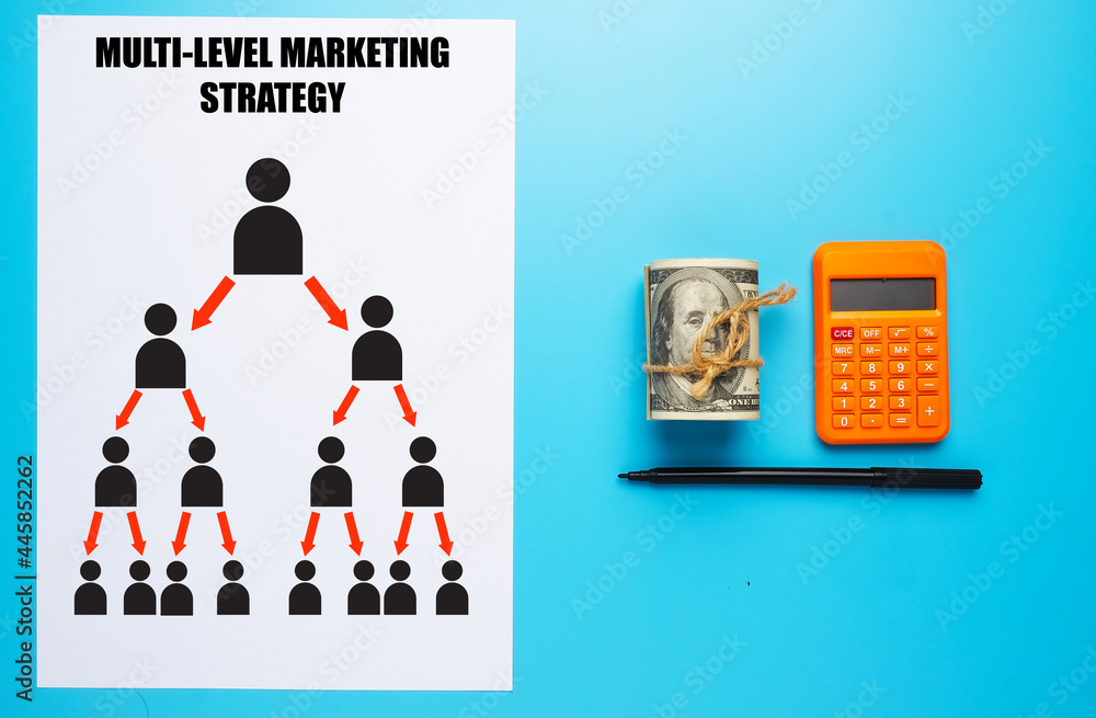 Paper with Multi-level marketing diagram, fake money, calculator and ...