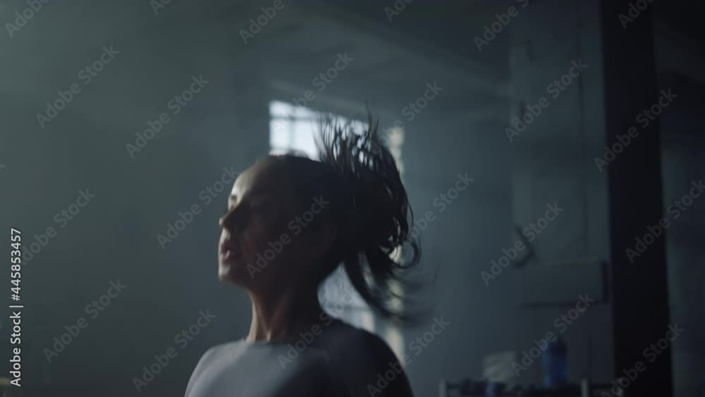 Woman jumping on skipping rope. Exhausted athlete finishing cardio ...