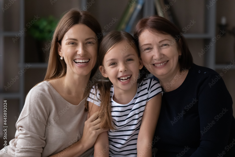 Family portrait of three female generations. Millennial mom, older ...