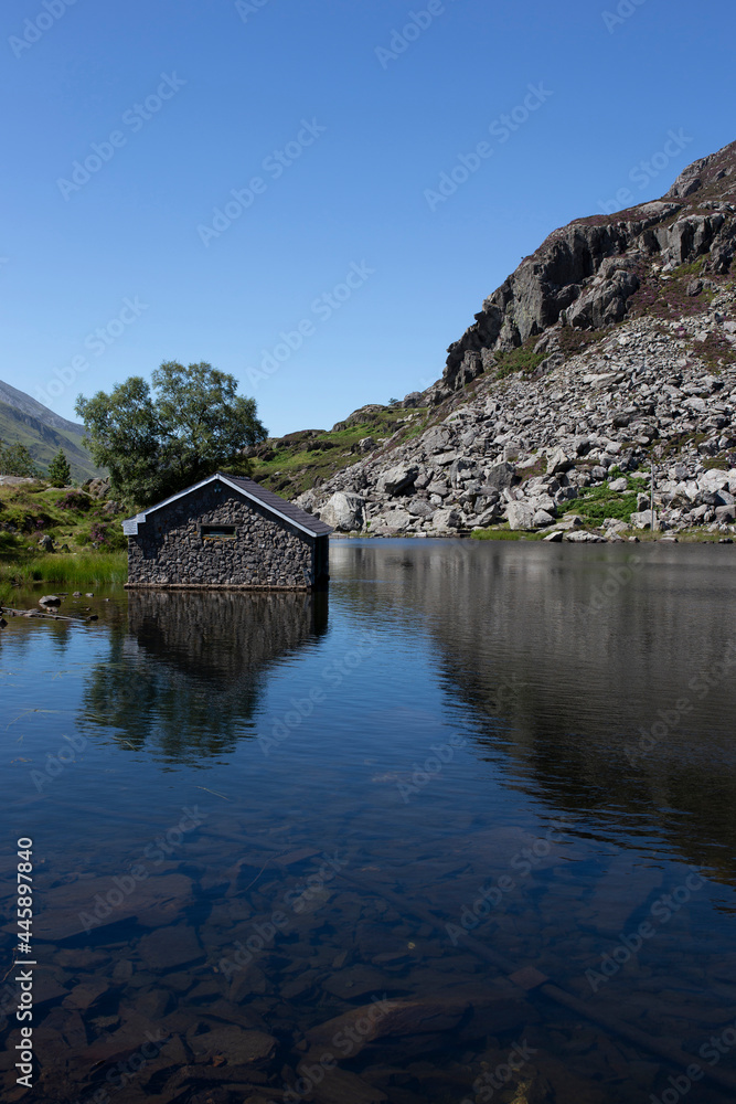 Llyn Ogwen, Ogwen lake, with building on the shore in Snowdonia ...